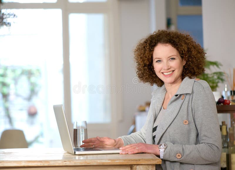 Happy Woman Using Laptop at Home Stock Image - Image of adult, middle ...