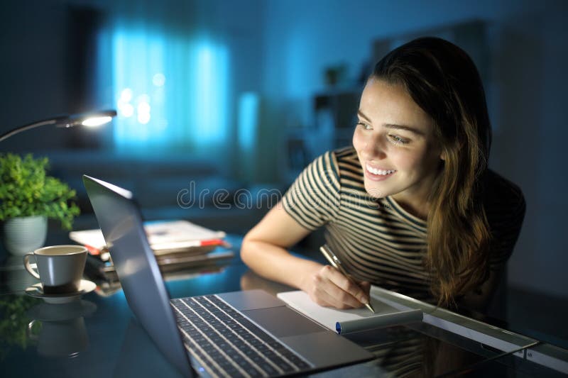 Happy Woman Using Laptop in the Night and Taking Notes Stock Photo ...