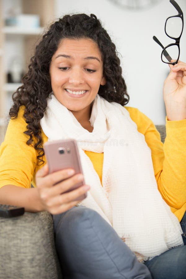 Happy Woman Using Mobile Phone on Sofa Stock Photo - Image of ...