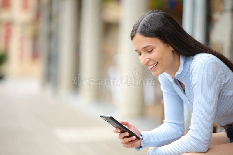 Happy Woman Using Phone in a Town Street Stock Image - Image of copy ...