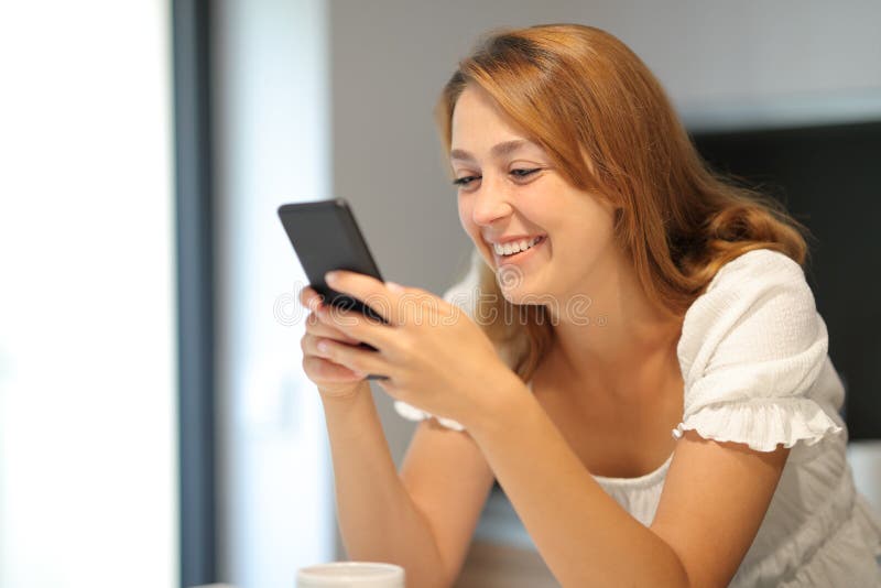 Happy Woman Using Smart Phone Smiling at Home Stock Photo - Image of ...