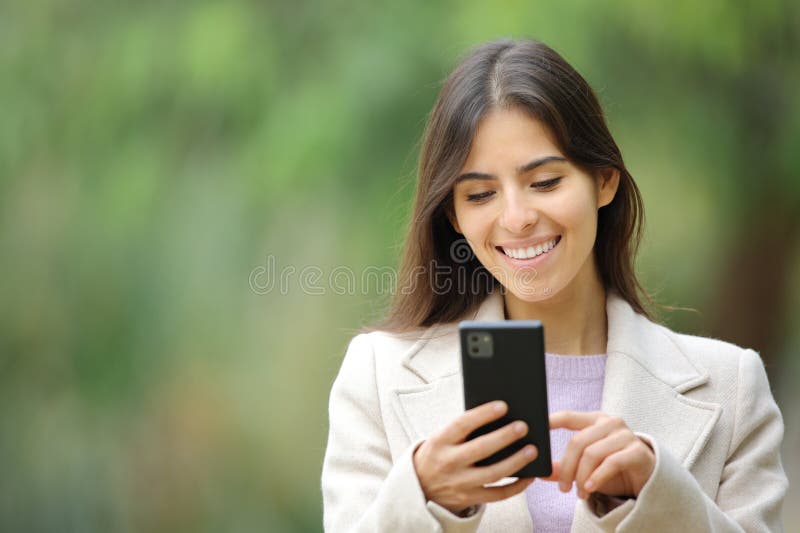 Happy Woman Walking Using Cell Phone in Winter Stock Image - Image of ...