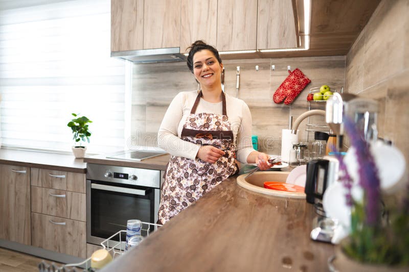 Happy Woman Wearing Apron in the Kitchen Stock Image - Image of indoors ...