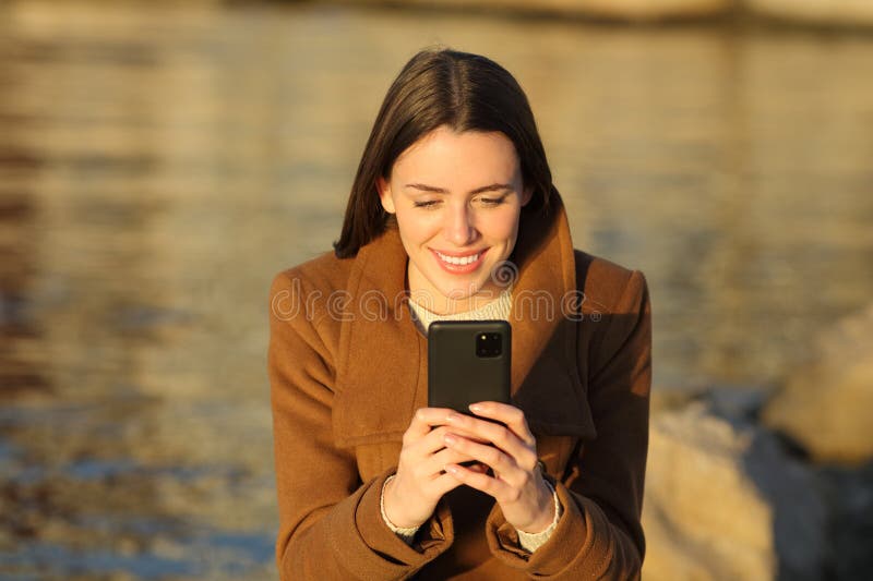 Happy Woman in Winter Using Mobile Phone Outdoors Stock Photo - Image ...