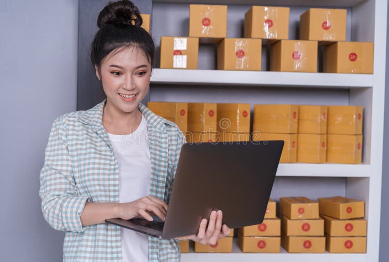 Happy Woman Working with Laptop Computer and Courier Parcel Box Stock ...
