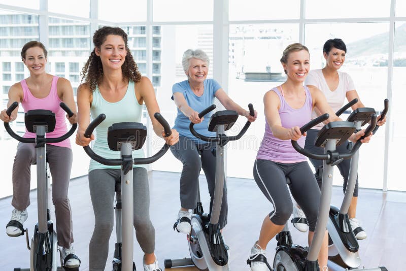 Happy Women Working Out at Spinning Class Stock Photo - Image of body ...