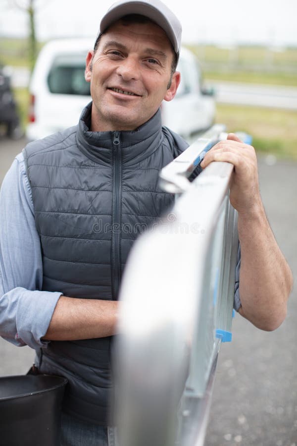 Happy Worker Carrying Ladder Outdoors Stock Photo - Image of happy ...