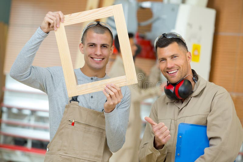 Happy worker making frame stock photo. Image of project - 261512934