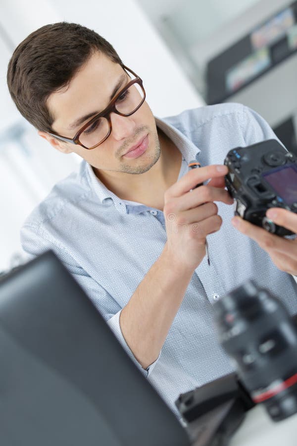 Happy Worker Technician at Work with Computer and Camera Stock Photo ...