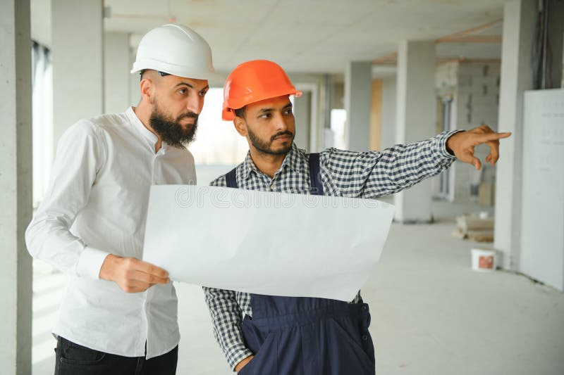 Young Civil Engineer Wearing Helmet Writing Report while Standing at ...
