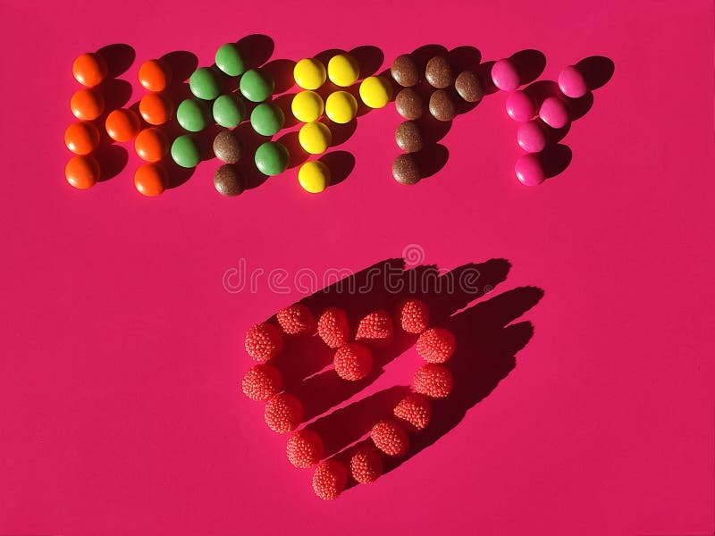 Happy Writing with Colored Dragees and a Heart Figure Stock Photo ...