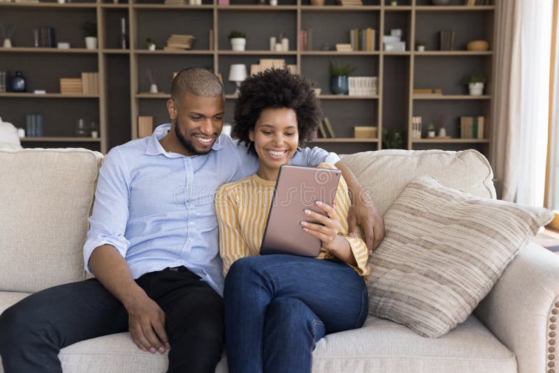 Happy Young African American Couple Using Tablet. Stock Image - Image ... Happy Young African American Couple Using Tablet. Stock Image - Image ...