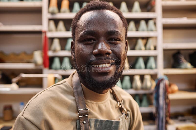Happy Young African American Shoemaker or Apprentice Looking at Camera ...