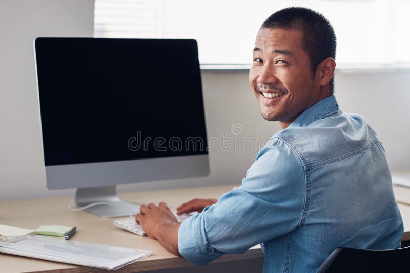 Happy Young Asian Entrepreneur at Work on an Office Computer Stock ...