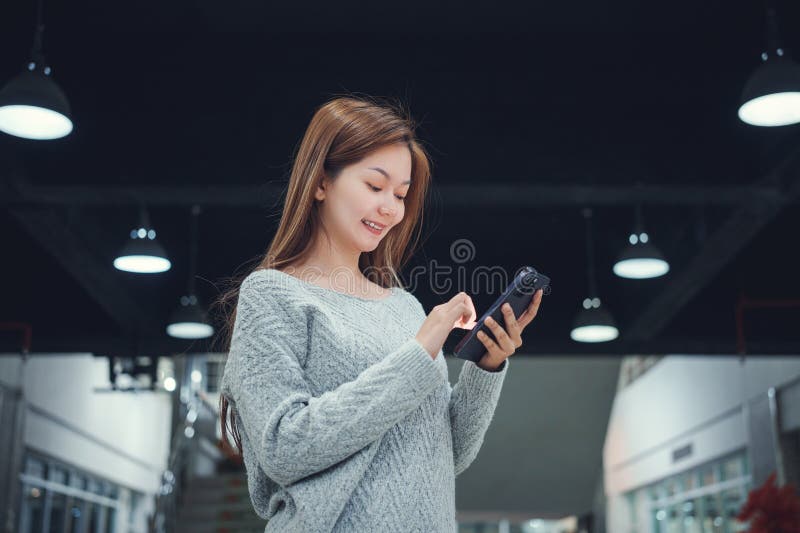 Happy Young Asian Woman Using on Mobile Phone in Library Stock Image ...