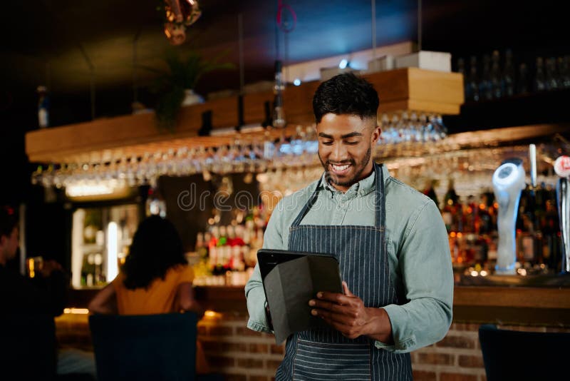 Happy Young Biracial Man in Apron Using Digital Tablet while Working As ...