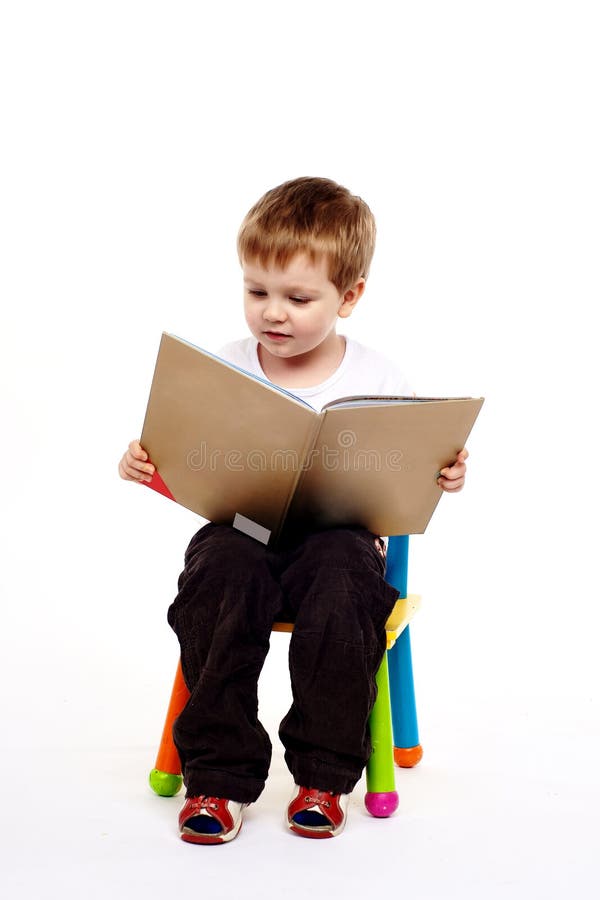 Happy young boy with book stock photo. Image of knowledge - 13738020