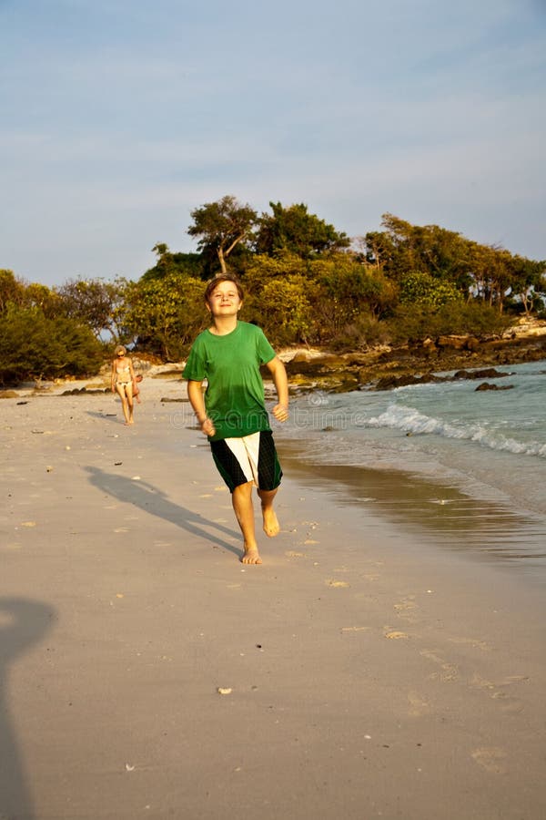 Happy Young Boy is Running Along Stock Photo - Image of holiday, relax ...
