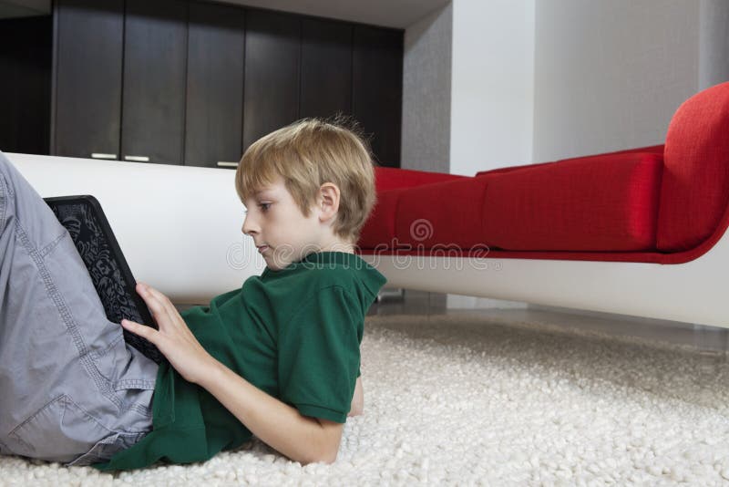 Happy Young Boy with Tablet Pc Sitting on Rug Stock Image - Image of ...