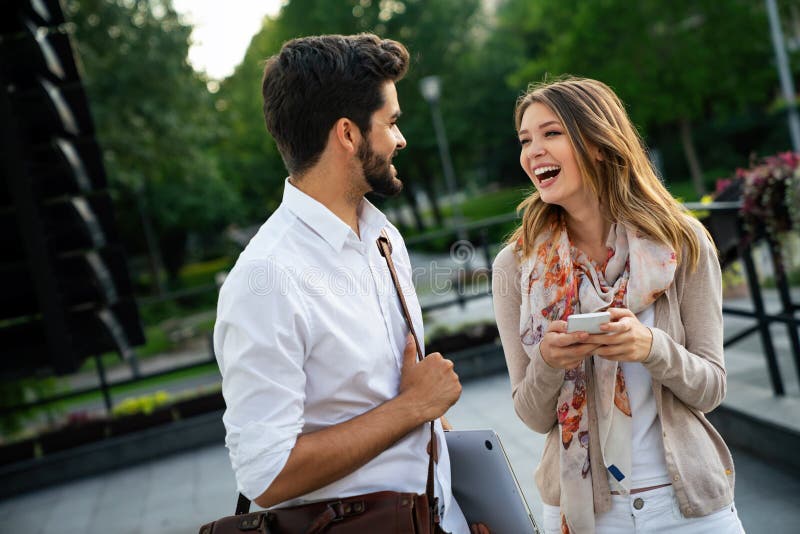 Happy Young Business People Chatting and Using Digital Devices Together ...