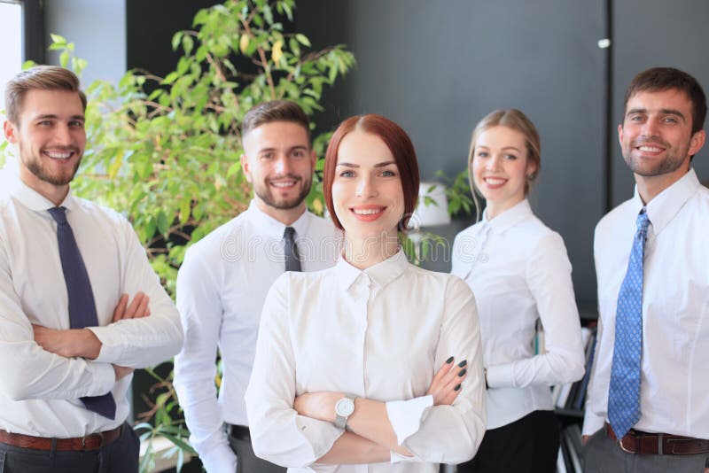Happy Young Business Woman Standing in Front of Her Team Stock Photo ...