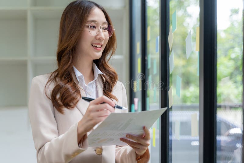 Happy Young Business Woman Working on Her Project at the Office Stock ...