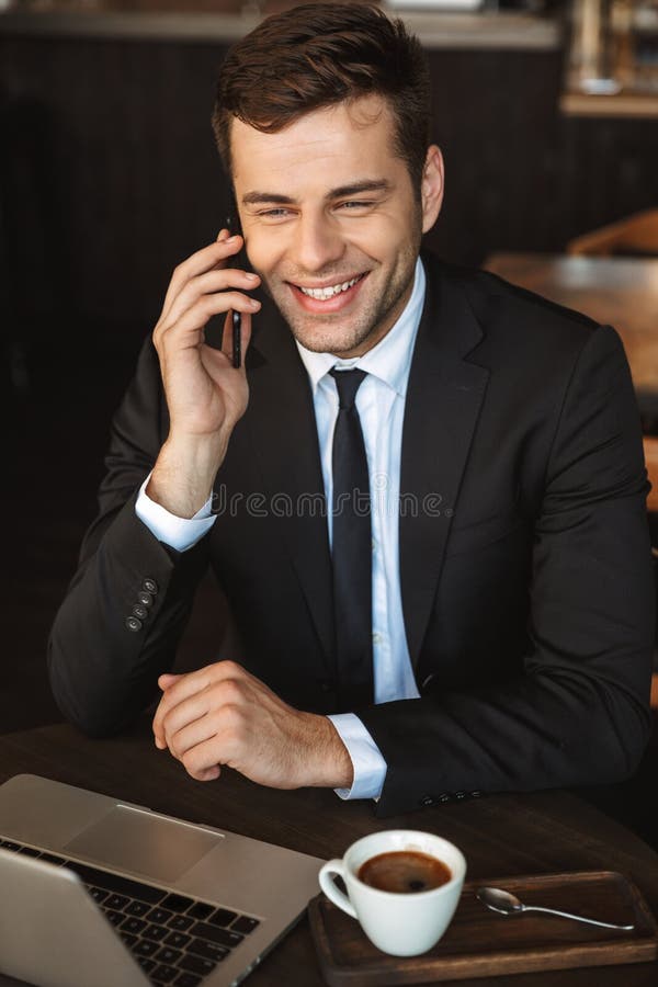 Happy Young Businessman Sitting in Cafe Using Laptop Computer Talking ...