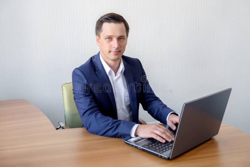 Happy Young Businessman Using Laptop at His Office Desk. Stock Image ...