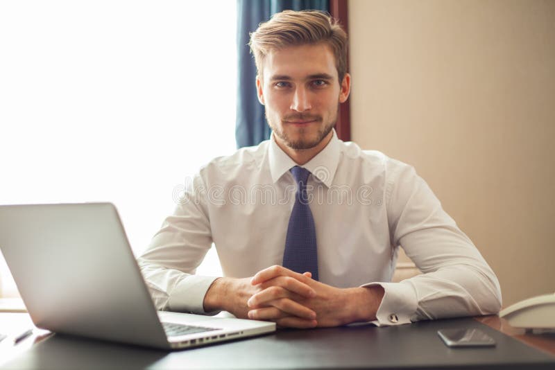 Happy Young Businessman Using Laptop at His Office Desk Stock Photo ...