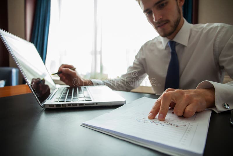 Happy Young Businessman Using Laptop at His Office Desk Stock Image ...