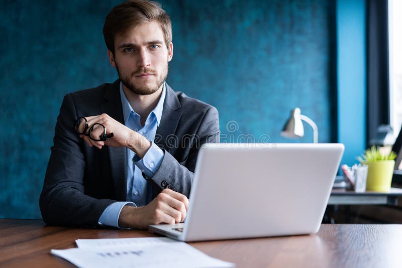 Happy Young Businessman Using Laptop at His Office Desk. Stock Image ...