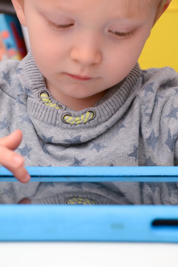 Child Using a Tablet Touch Screen Device Stock Photo - Image of indoors ...
