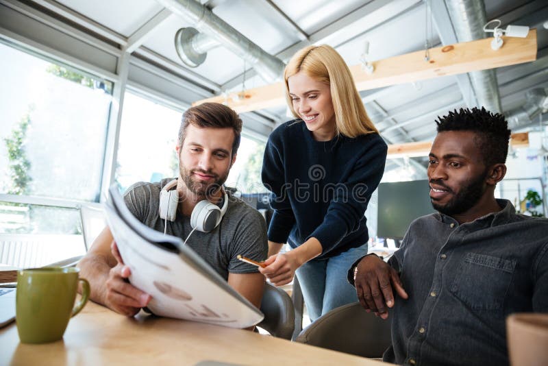 Happy Young Colleagues Talking with Each Other. Stock Image - Image of ...