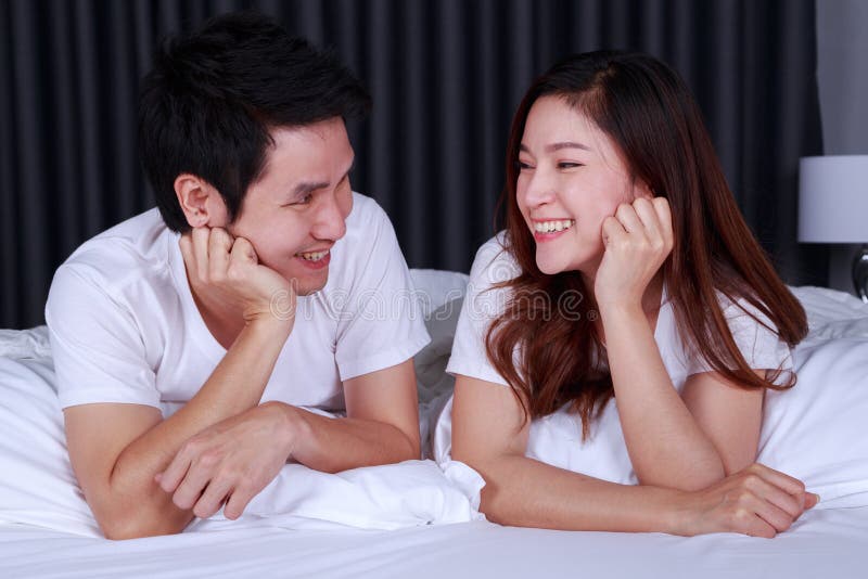 Happy Young Couple on Bed in Bedroom Stock Photo - Image of husband ...