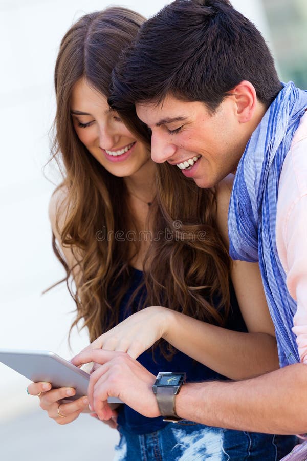 Happy Young Couple Browsing Internet with Digital Tablet in the Stock ...