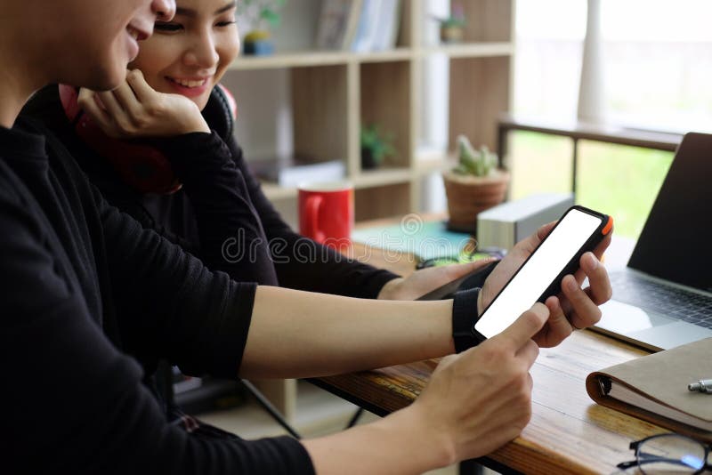 Happy Young Couple Browsing Internet on Smartphone Gadgets Together at ...