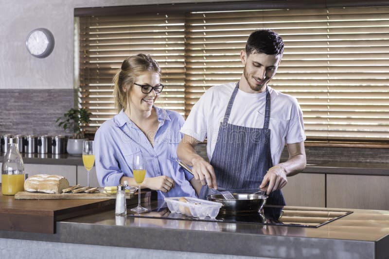 Happy Young Couple Cooking Breakfast Preparing in the Kitchen Stock ...