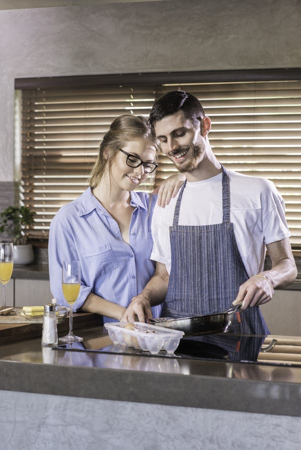 Happy Young Couple Cooking Breakfast Preparing in the Kitchen Stock ...