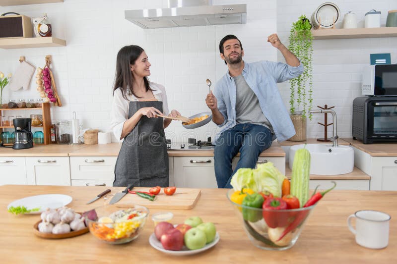 Happy Young Couple Cooking Together in the Kitchen at Home Stock Image ...