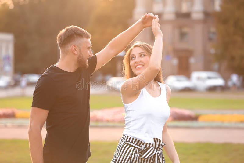 Happy Young Couple Dancing Outdoors Stock Image - Image of outdoors ...