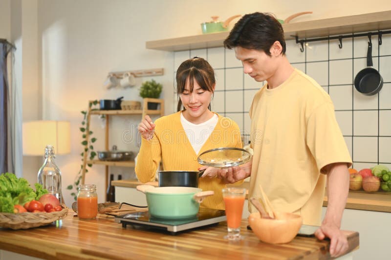 Happy Young Couple Enjoying Cooking Together in a Modern Kitchen Stock ...