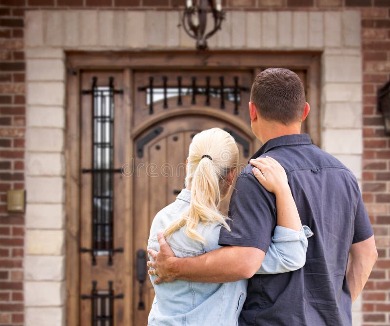 Happy Young Couple Facing Front Door Of New House Stock Photo - Image ...