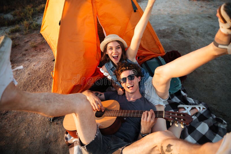 Happy Young Couple Having Fun Camping by a Lake Stock Photo - Image of ...