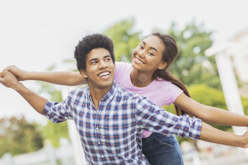 Happy Young Couple Having Fun and Fooling Around Together Outdoors ... Happy Young Couple Having Fun and Fooling Around Together Outdoors ...