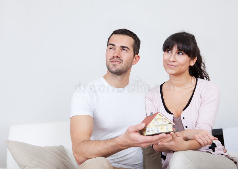 Happy Young Couple Holding a House Model Stock Image - Image of casual ...