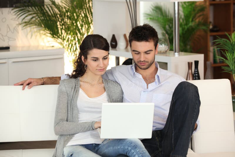 Happy young couple at home stock image. Image of good - 23296325