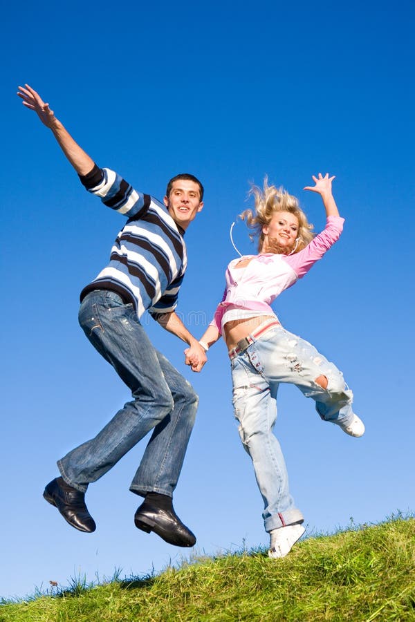 Happy Young Couple Jumping in Sky Stock Image - Image of active, beauty ...