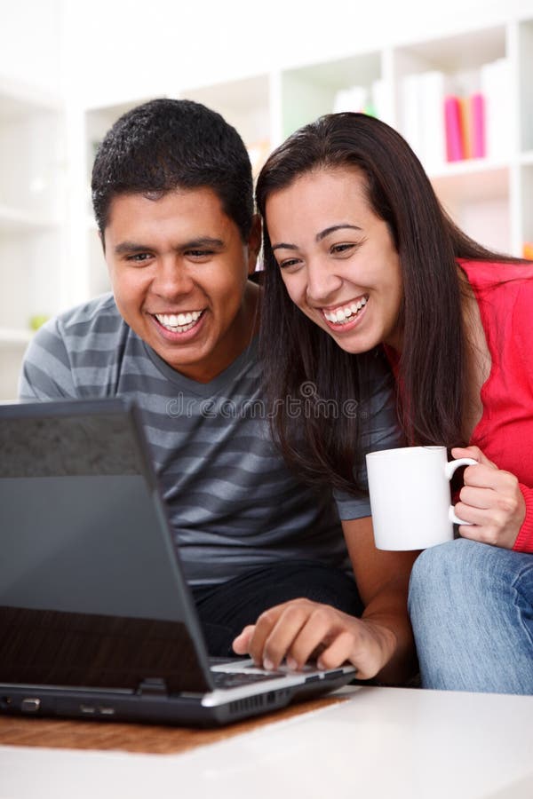 Happy Young Couple Looking at a Laptop Stock Photo - Image of looking ...