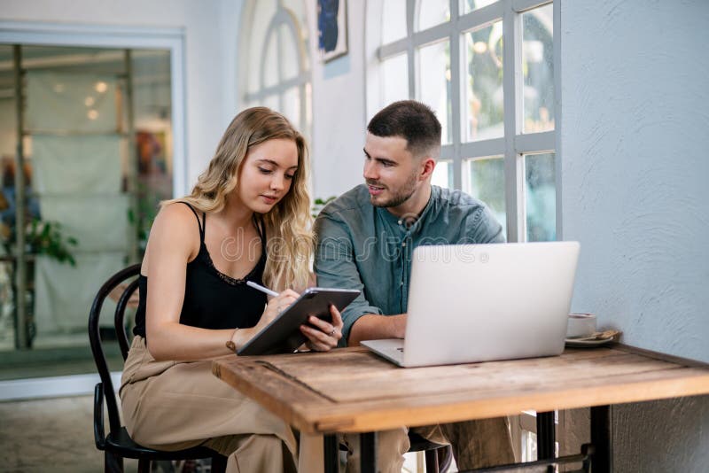 Happy Young Couple Looking at Laptop Computer Together at Home. the ...