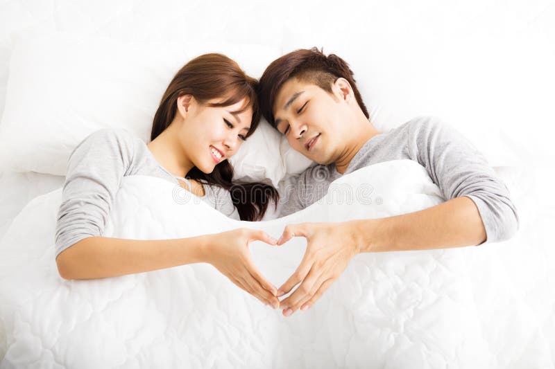 Happy Young Couple Lying in a Bed Stock Photo - Image of bedroom ...